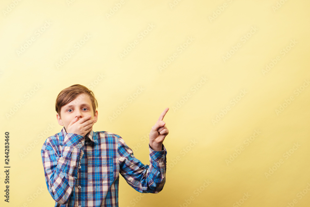 surprised startled amazed astounded and stunned boy points with index ...