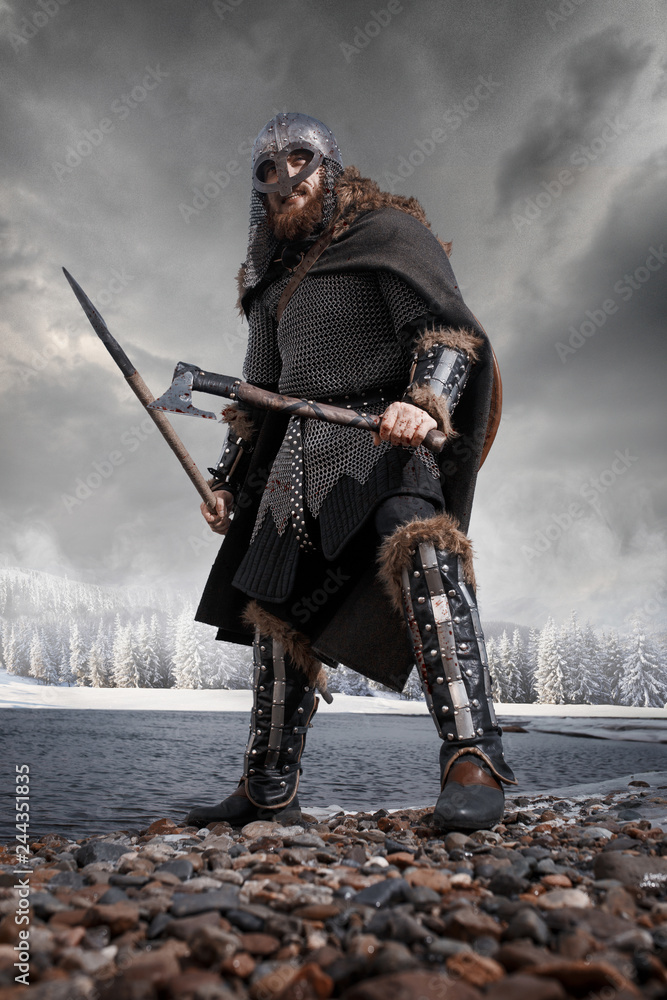 Medieval Scandinavian warrior Viking in full outfit on shore of winter ...