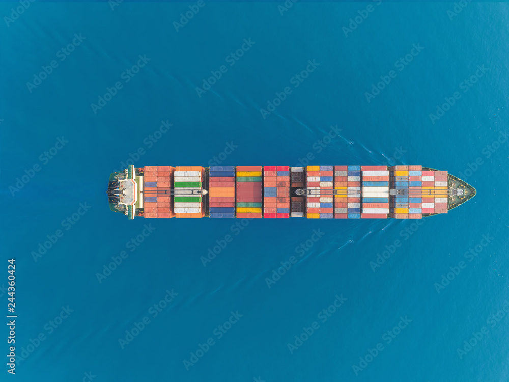 Aerial top view container ship at sea port and working crane bridge for ...