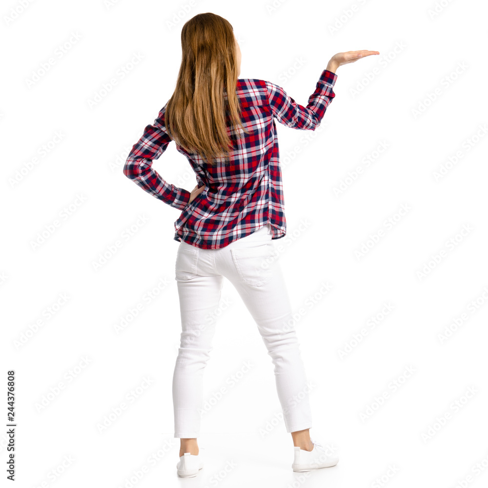 Woman in white jeans and shirt showing on white background isolation ...