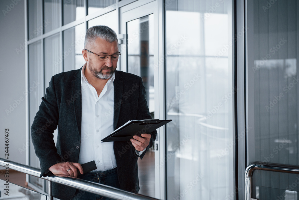 Waiting for the employee. Photo of senior businessman in the spacious ...