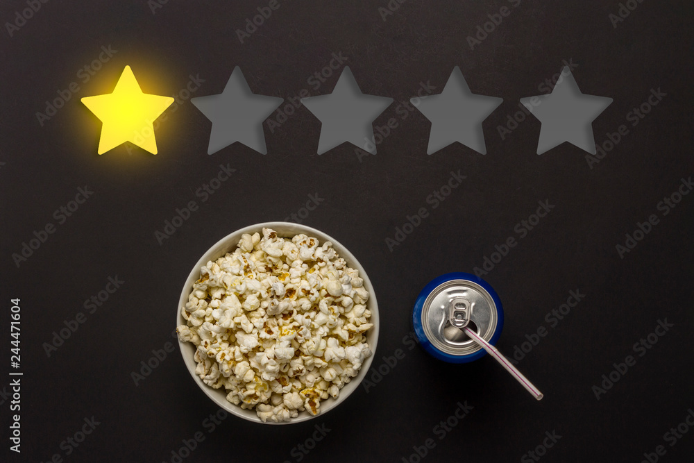 Bowl of popcorn and can with drink on a black background. Added one ...