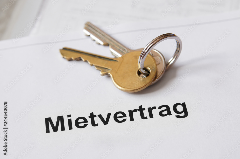 German lease agreement document with set of house keys. Mietvertrag ...