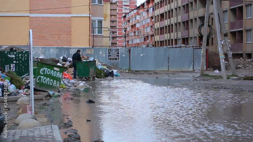 Terrible view garbage dump in residential yard and huge puddle through ...