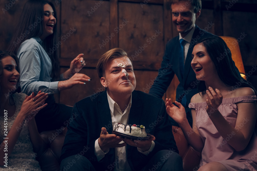 Handsome man's face covered in birthday cake Stock Photo | Adobe Stock