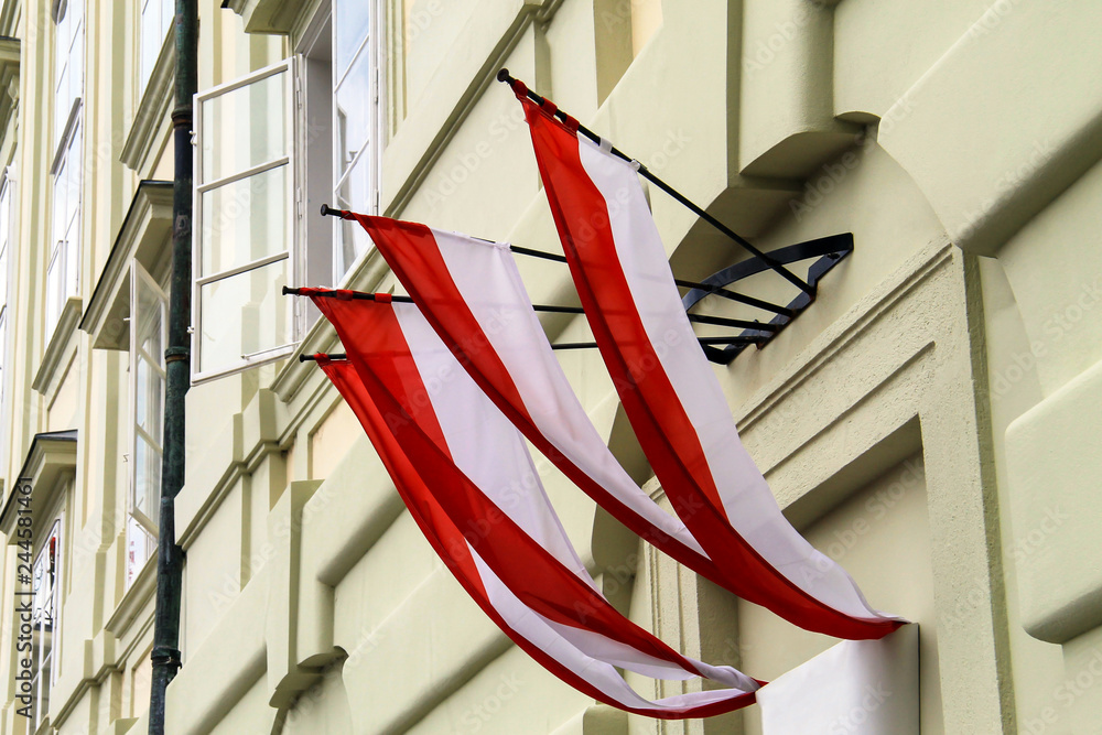 Red and white flags of the city of Vienna on the facade of the Imperial ...