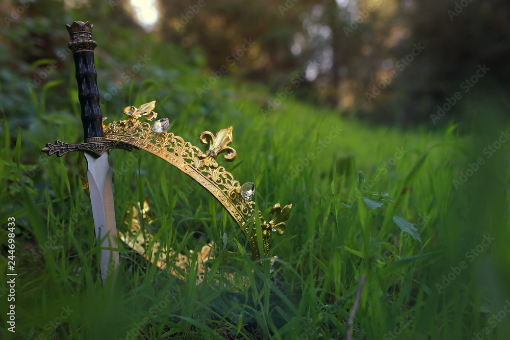 mysterious and magical photo of gold king crown and sword in the ...