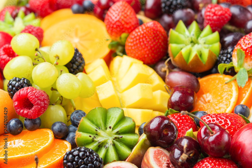 Healthy fruit background filled with strawberries raspberries oranges ...
