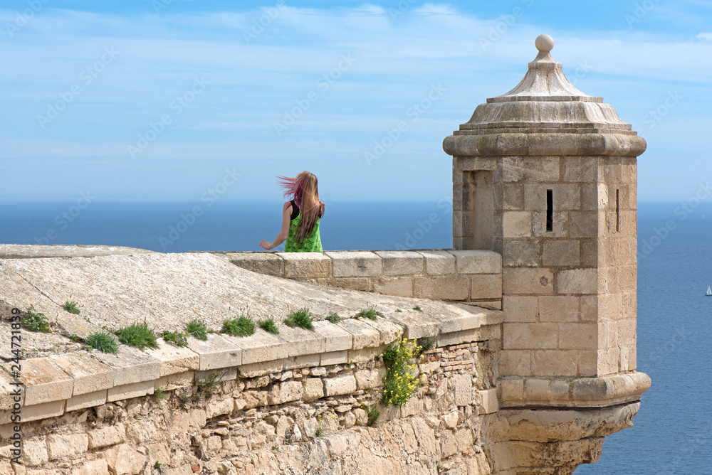 Young girl exploring ancient fortress built on top of mountains to ...