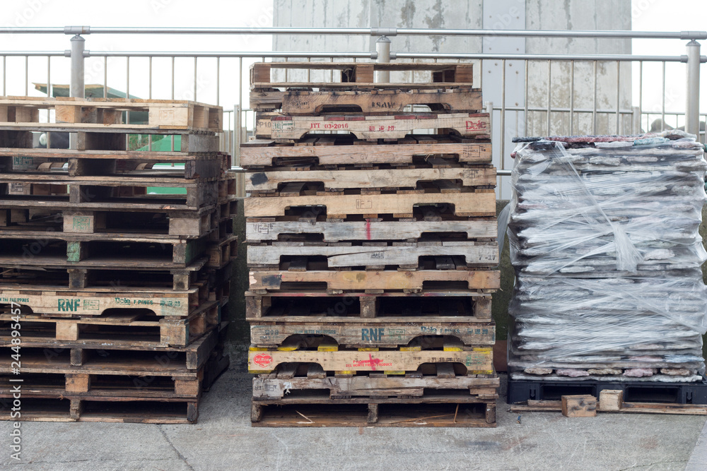 Piled wooden pallets at harbor Stock Photo | Adobe Stock
