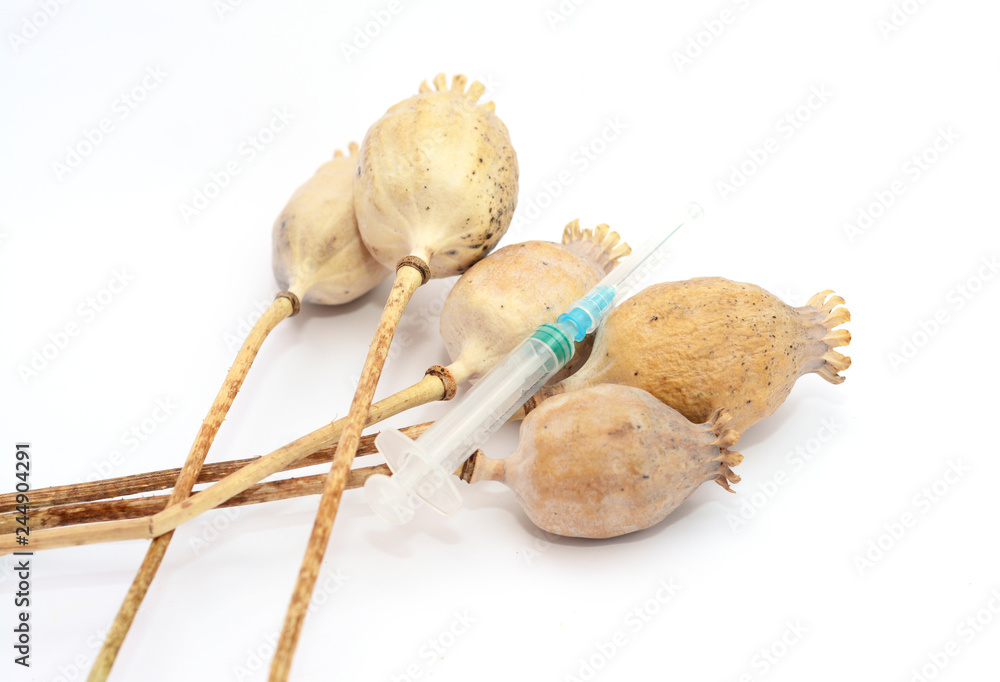 Heroin Addiction. Hypodermic syringe with blue needle and dry opium ...