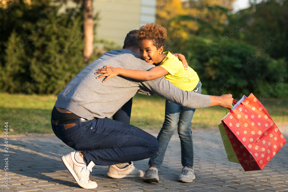 Little girl running into her father's arms. Dad and his daughter ...