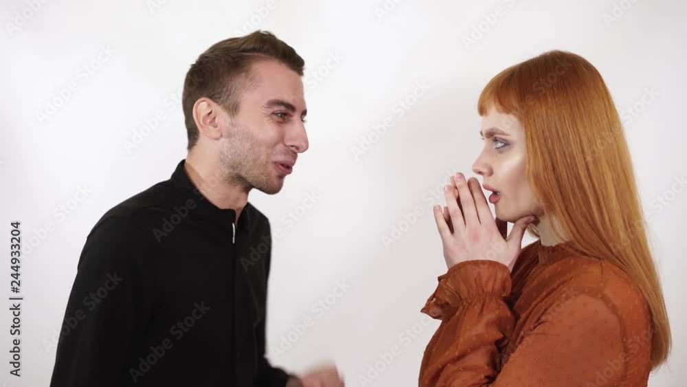 Angry agressive man yelling at his beautiful girlfriend with long red ...