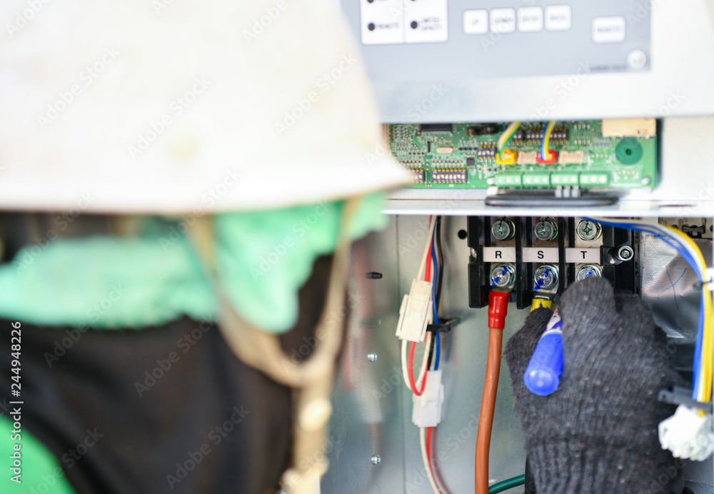 Technician marking after torque main cable power supply to connecting ...
