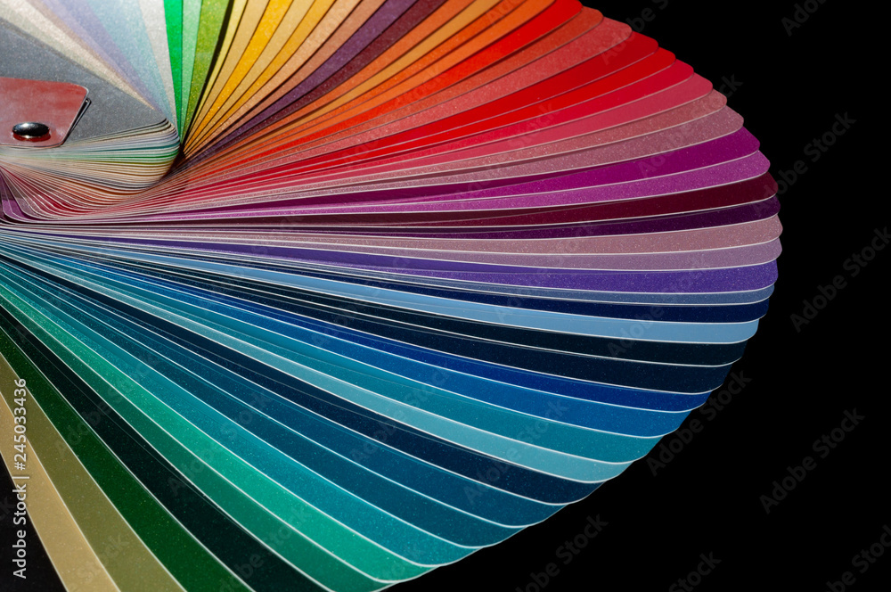 Color fan deck with samples of various paint isolated on a black ...