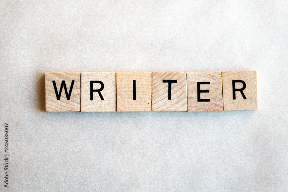 The word Writer spelled in square wooden blocks on a white background ...