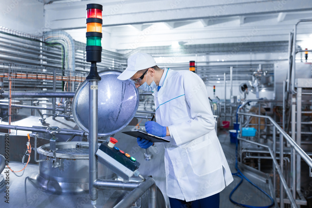 man in a white robe and mask makes notes standing in the shop Stock ...