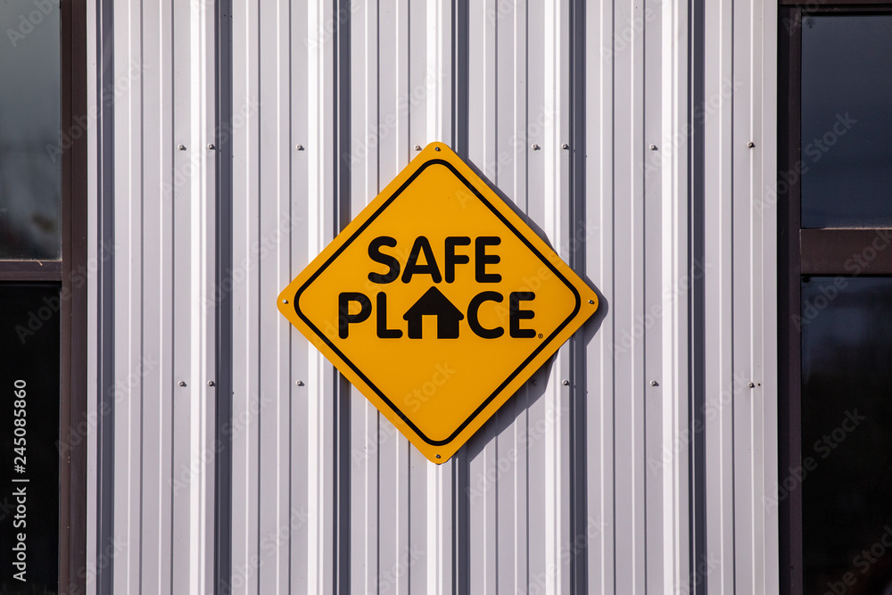 Safe place sign of a light metal wall of a building. Stock Photo ...