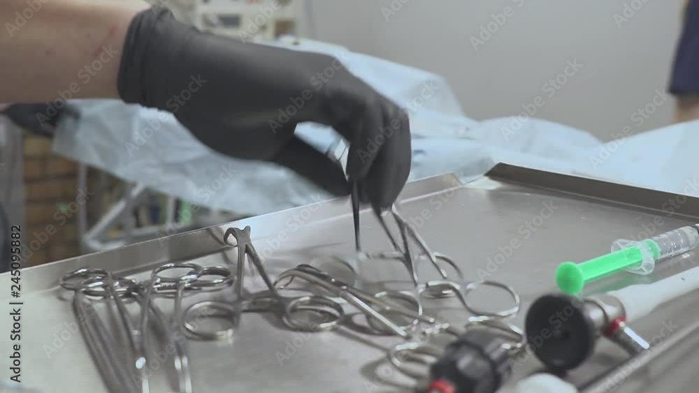 Close up hands and a table of surgical nurse during laparoscopic ...