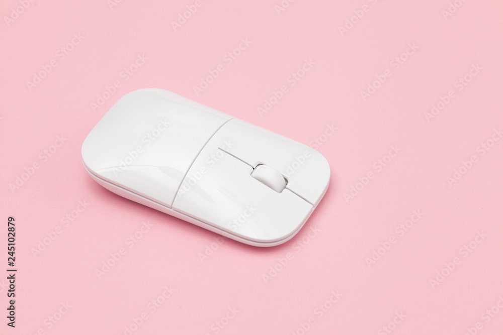 White wireless optical mouse with a wheel on a pink background. Modern ...