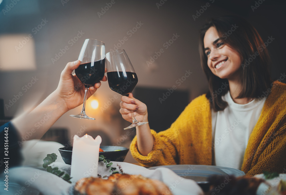 Romantic dinner, beautiful young couple having dinner drinking red wine in restaurant, best ...