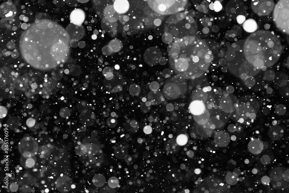 Real snow falling on black background. Falling snow of different shapes ...