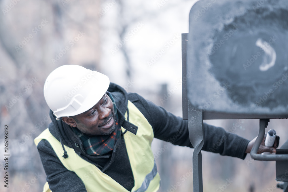 African American railroad engineer wearing safety equipment (helmet and ...