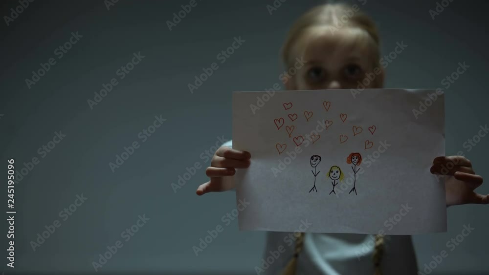 Sad girl showing family picture to camera, little refugee missing lost ...