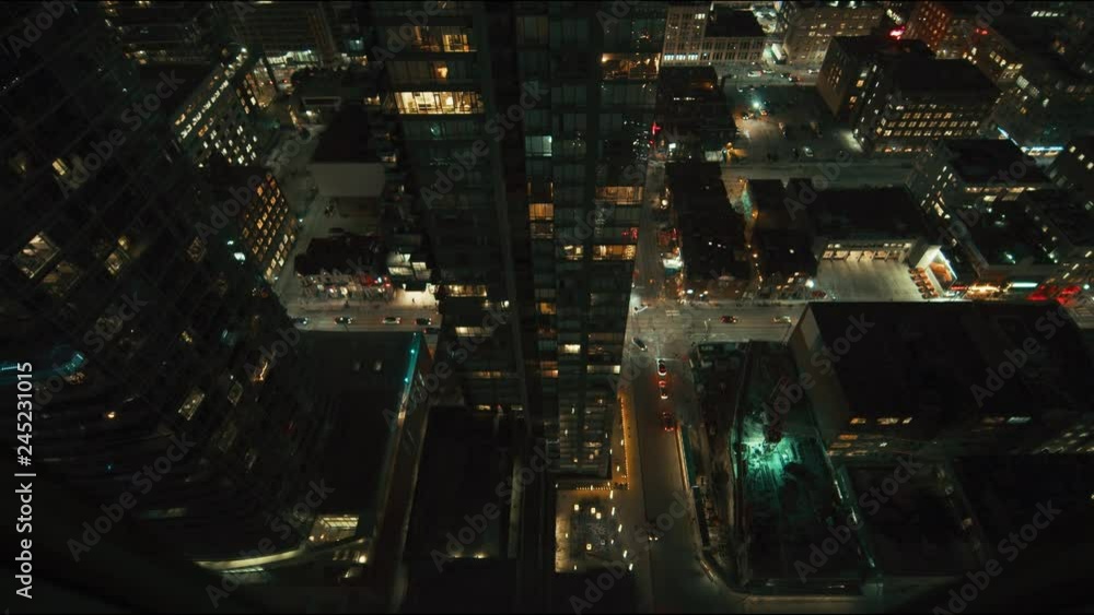 Wide angle down shot of city skyscraper at night with lights on. Dark ...