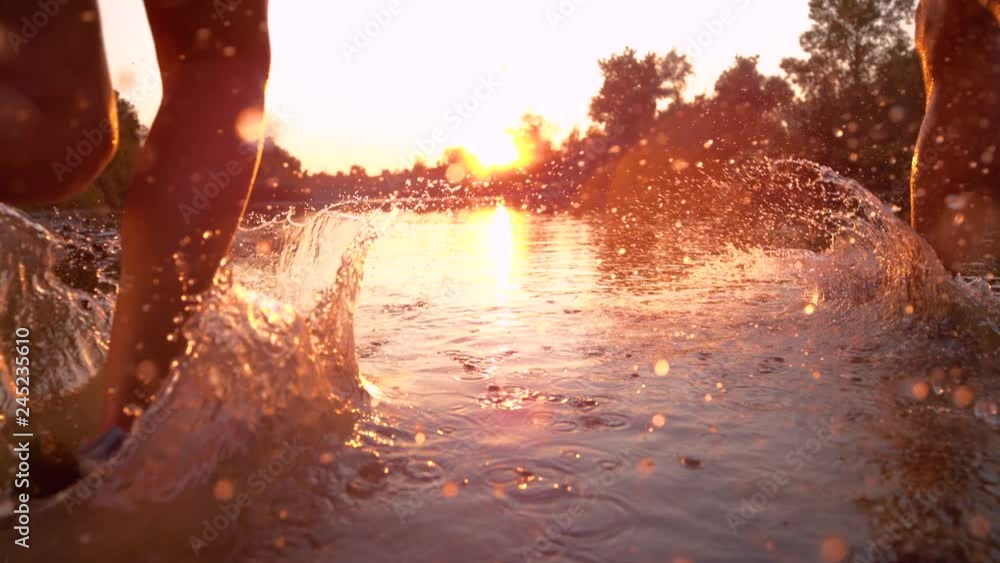 SUPER SLOW MOTION, CLOSE UP, LENS FLARE: Unrecognizable active woman ...