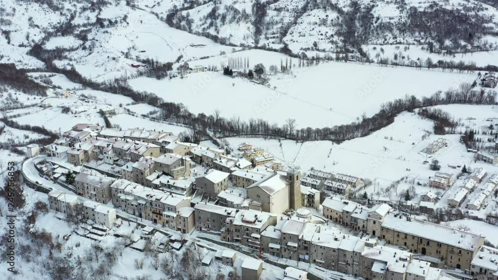 Aerial view of the beautiful snow-covered village of Opi with snow ...