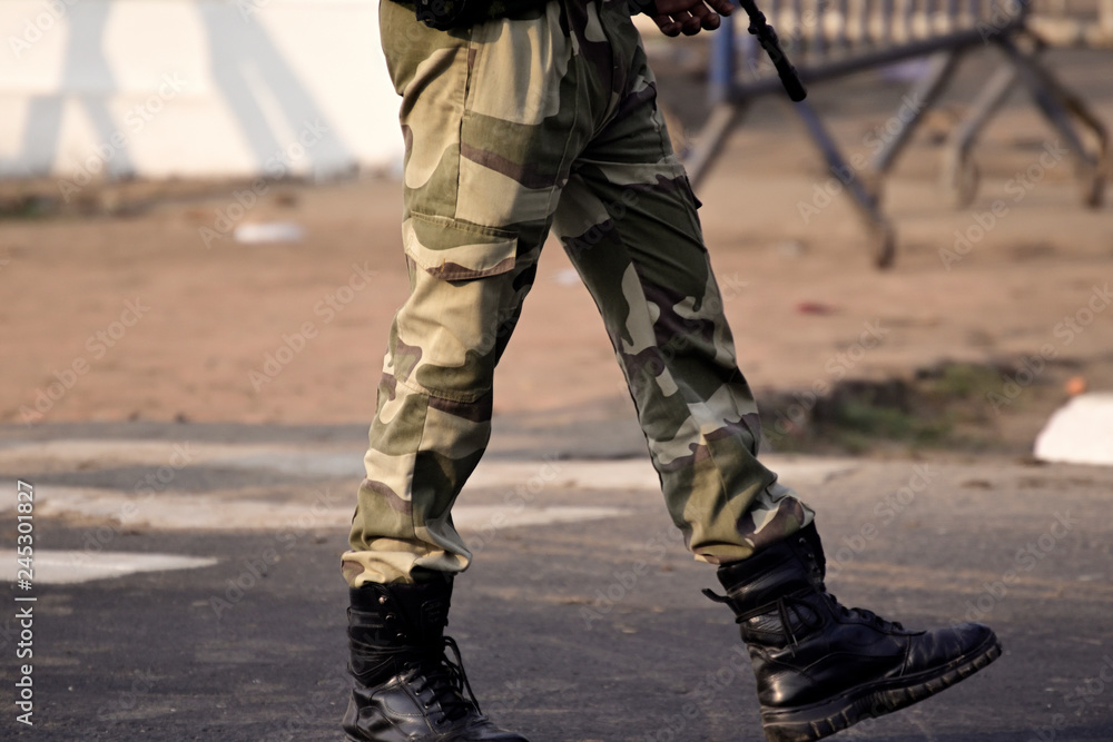 Security guard with rifle standing on outside to protect the area ...