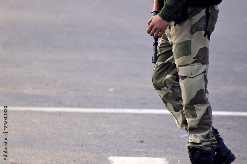 Security guard with rifle standing on outside to protect the area ...