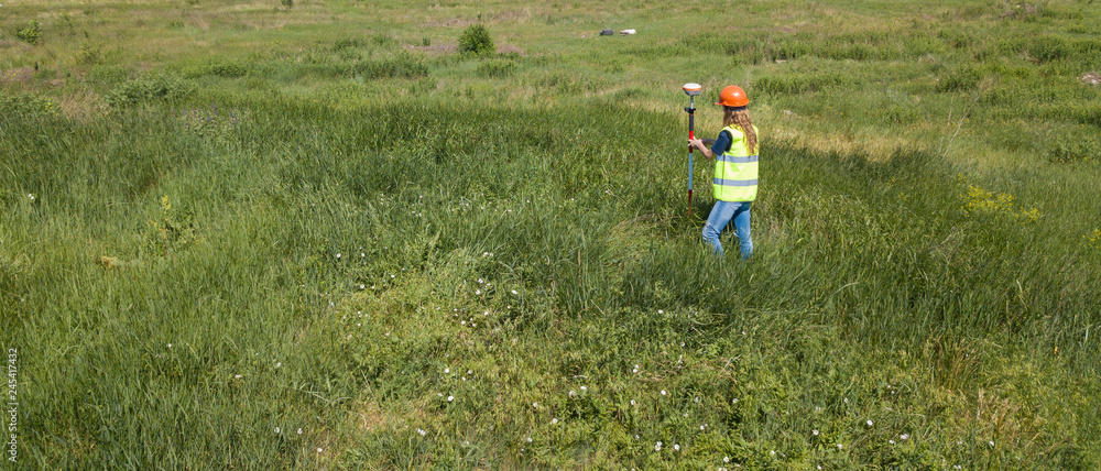 Professional Female Land Surveyor Measures Ground Control Point Using a ...