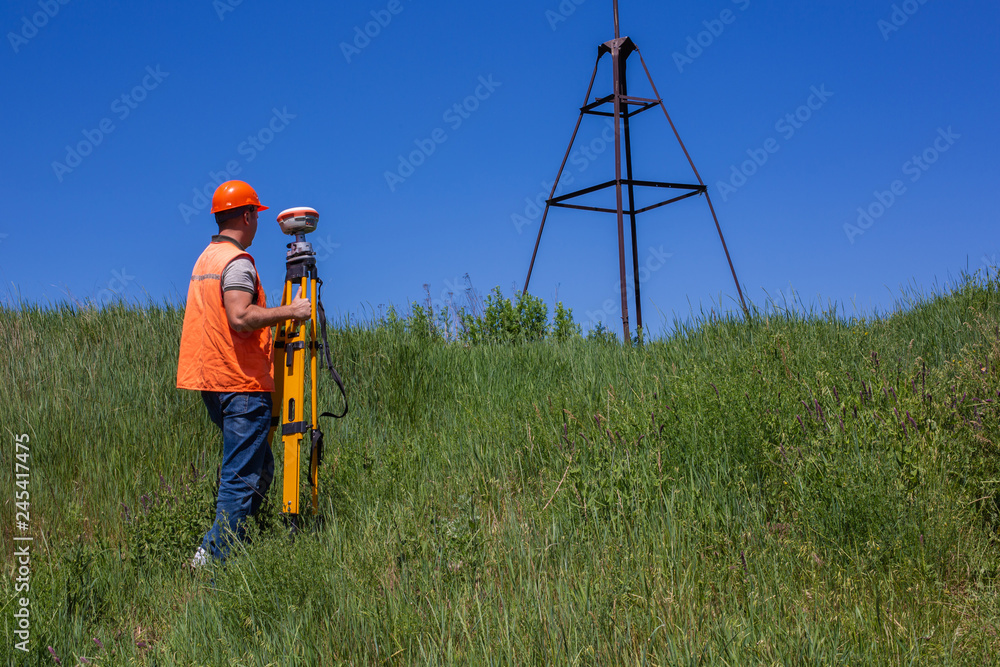 Foto de Professional Male Land Surveyor Measures Ground Control Point ...