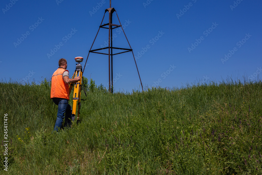 Professional Male Land Surveyor Measures Ground Control Point Using a ...
