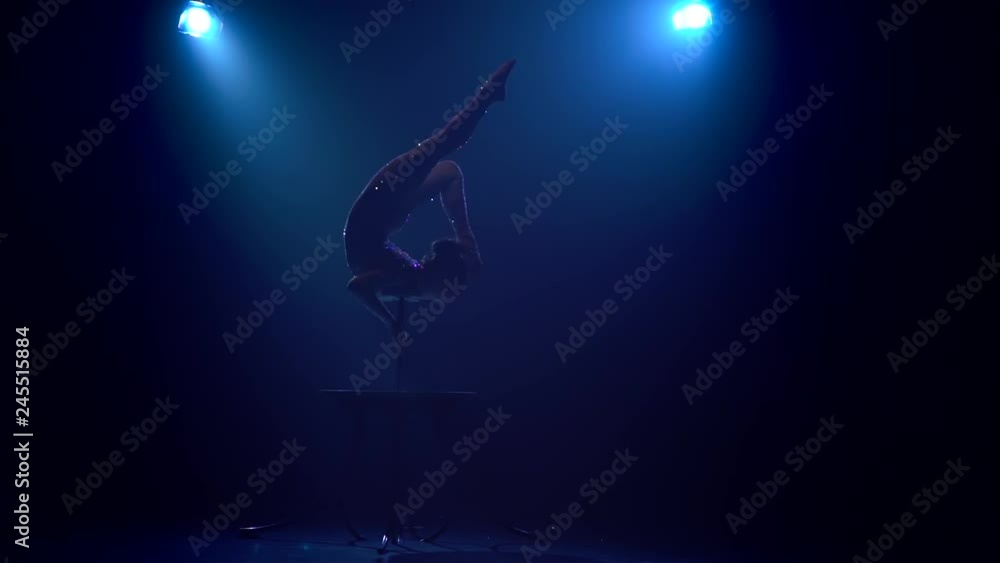 Girl performs on stage with various acrobatic stunts in a brilliant ...