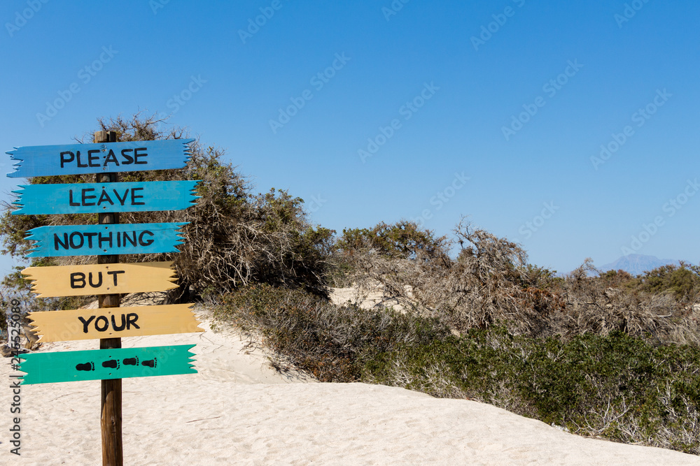Please leave nothing but your footprints - colorful wooden sign on a ...
