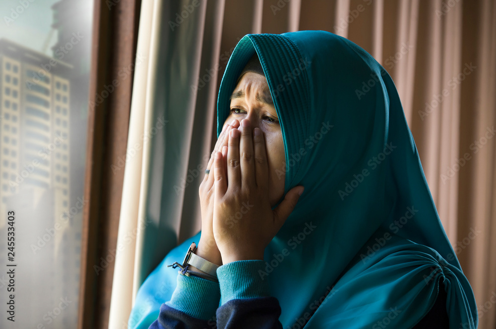 young sad and depressed Muslim woman in Islam traditional Hijab head ...