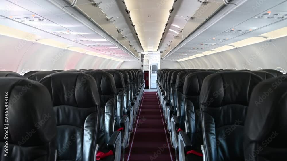 4K Interior of commercial airplane cabin with black and red passenger ...