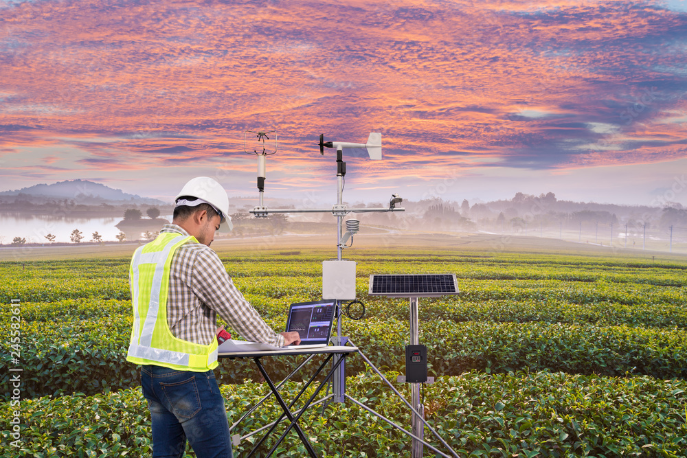 Agronomist using tablet computer collect data with meteorological ...