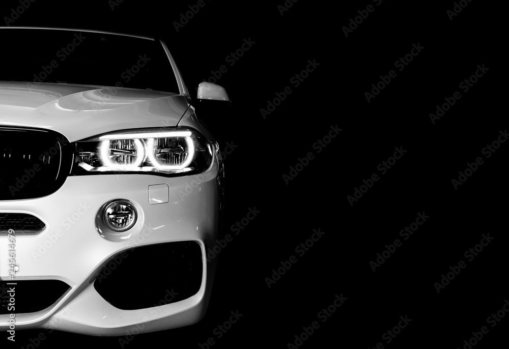 Headlight of a modern white sport car. The front lights of the car ...