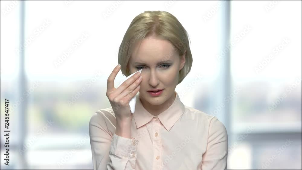 Young crying woman on blurred background. Upset middle-aged business ...