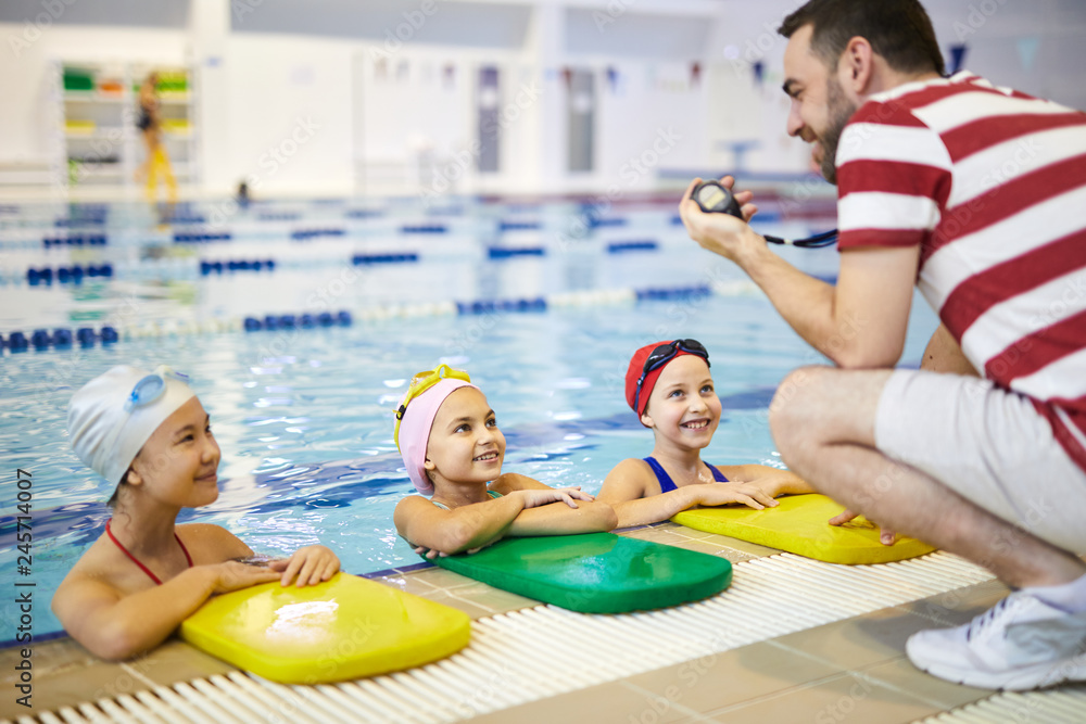 Group of little girls listening to recommendation of the trainer before ...
