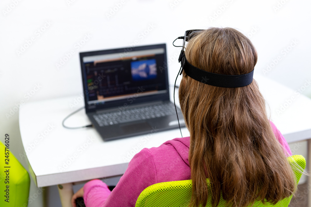 Young teenage girl during EEG neurofeedback session ...