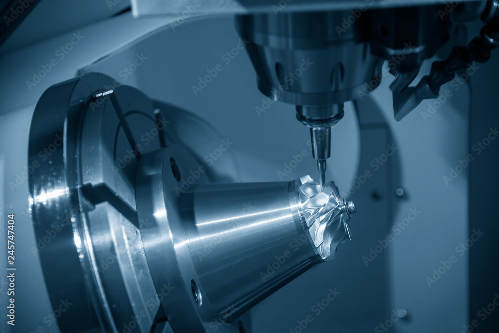 The 5-axis CNC milling machine cutting the aluminium turbine part.The ...