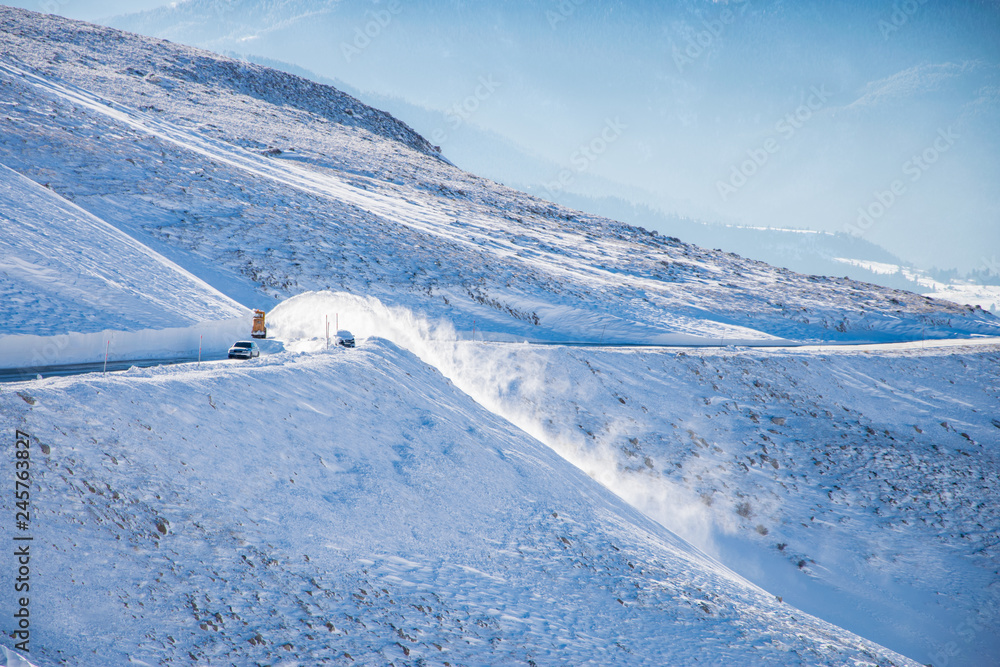 View from Velouchi mountain where a snowplow is clearing the road from ...
