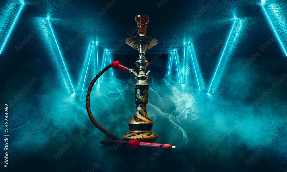 Smoking hookah on the background of an empty room, blue neon light ...