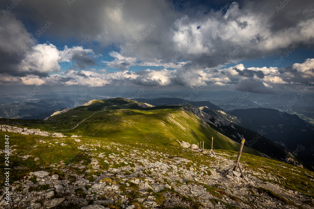 Rocky path and grassy rax plateau on hike Dambocksteig from Schneeberg ...