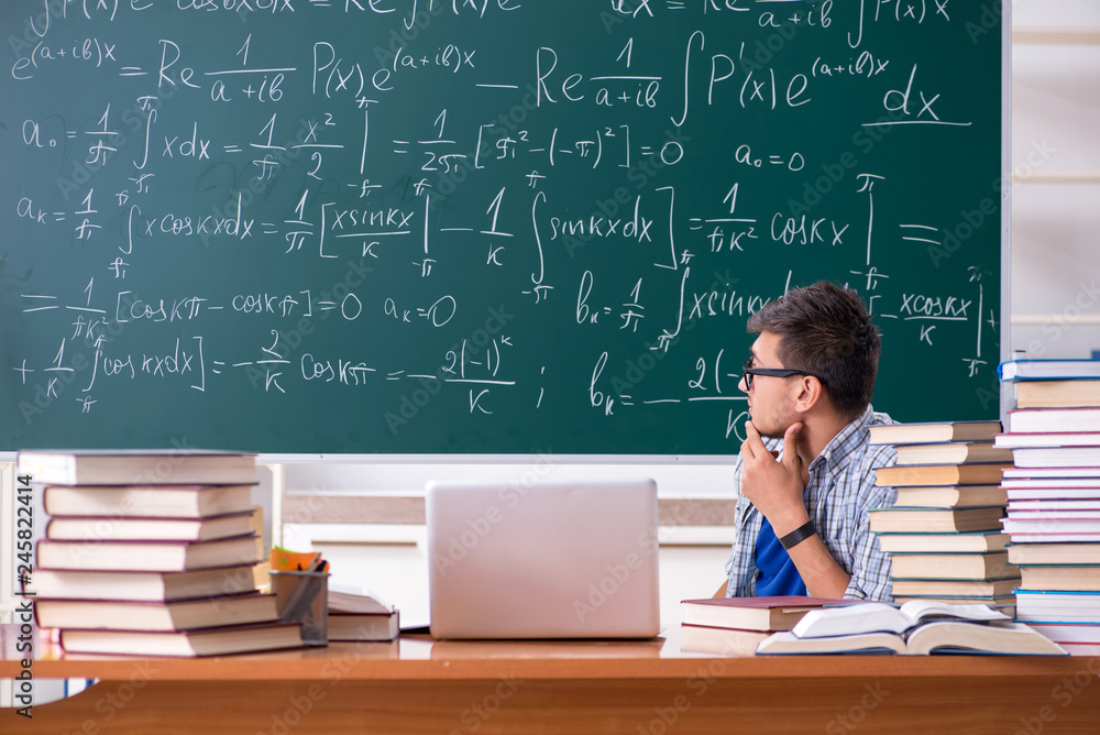 Young male student studying math at school Stock Photo | Adobe Stock